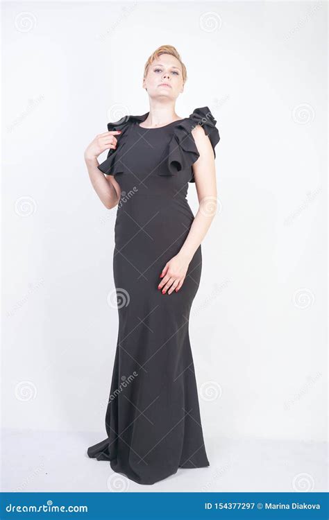 Portrait Of Attractive Chubby Young Woman In Tight Black Dress Stock