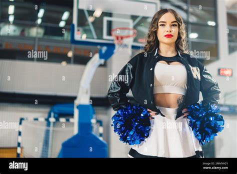 Horizontal Medium Shot Of A Cheerleader In Black And White Uniform