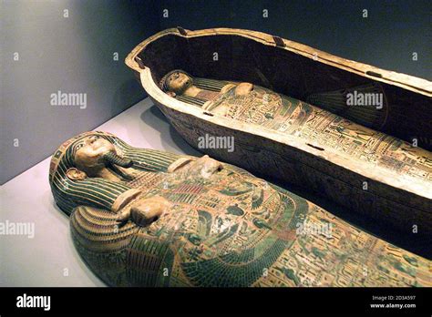 An Open Sarcophagus Showing A Statue Of A Mummy Inside For The Ancient