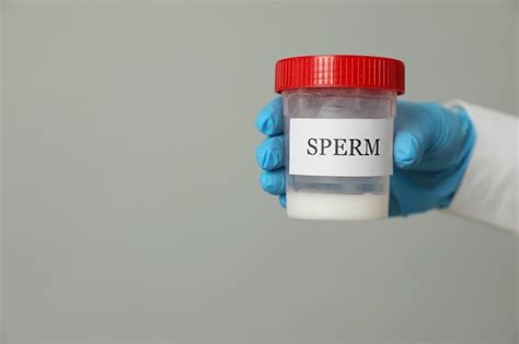 Premium Photo Scientist Holding Container With Sperm On Grey
