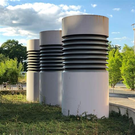 Premium Photo Metal Structure On Grass Against Sky
