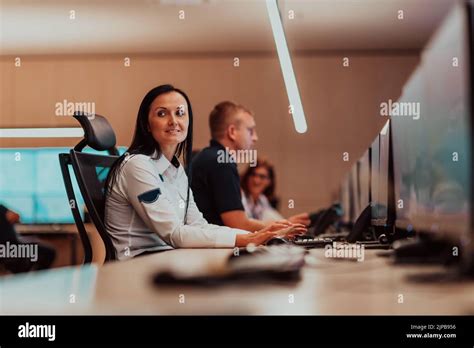 Female Security Operator Working In A Data System Control Room Offices Technical Operator