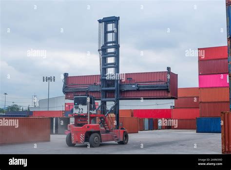 Container Handlers In The Harbor With Storage Cabinet Background