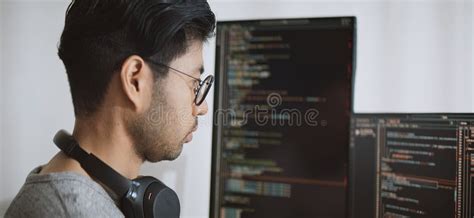 Asian Male Software Developer Coding Program On Desktop Computer Man