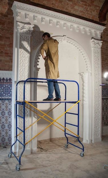 Premium Photo A Man Stands On A Scaffolding That Has A Blue And