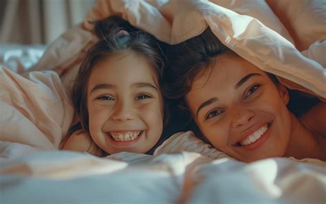 A Mother And Daughter Share A Moment Of Joy Under The Covers Premium