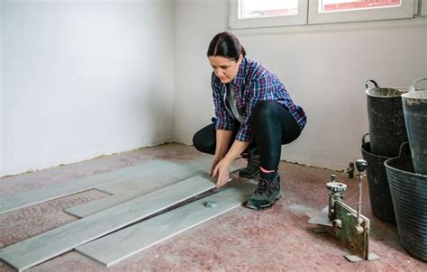 Premium Photo Female Bricklayer Placing Tiles To Install A Floor