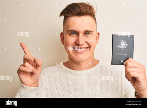 Young Handsome Man Holding Australia Australian Passport Over Isolated