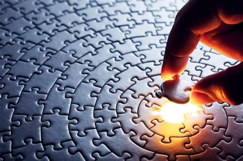 Premium Photo Hand Inserting Missing Puzzle Piece
