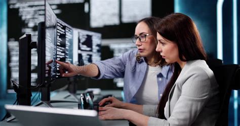 focused woman programmer developing software code on computer screen