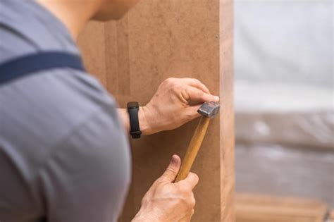 Premium Photo Managing Carpentry Business Man Installing Shelf