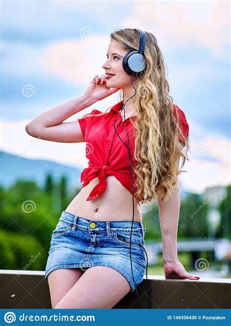 Student Girl With Backpack Headphone Listen Music On Green Grass