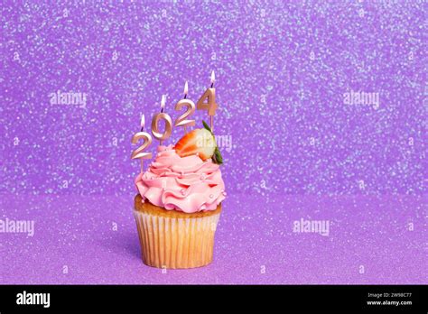 Cupcake With Candles Forming Number 2024 For Happy New Year New Year