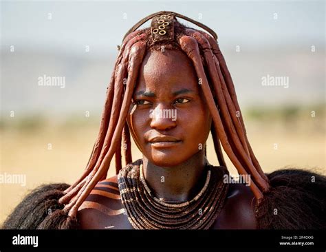 Portrait Of A Young Woman Of The Himba Tribe With A Traditional
