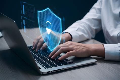 Person Typing With Digital Shield Overlay On Laptop For Data Protection Seated At Desk Premium