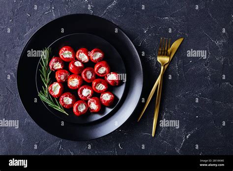 Italian Ricotta Stuffed Hot Cherry Peppers Served On A Black Plate With