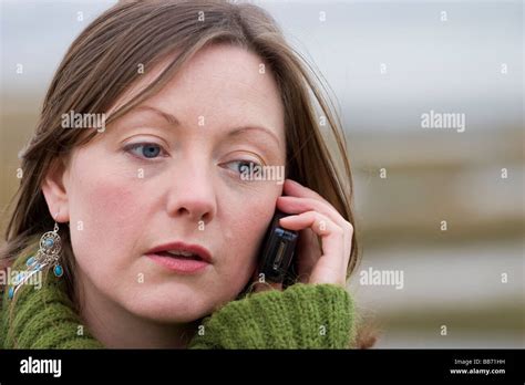 Close Up Of A Woman In Her 30s Outdoors On Her Mobile Phone Looking