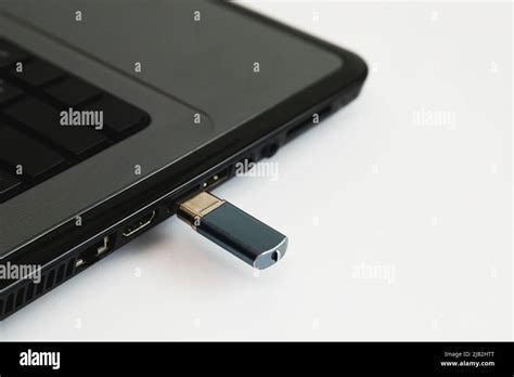 Removable Flash Disk Memory In Laptop Usb Socket On White Background