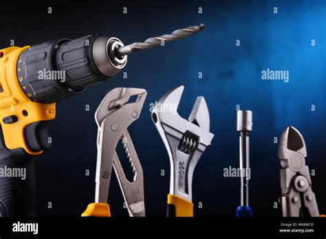 Composition With Hardware Tools Including Cordless Drill And Monkey