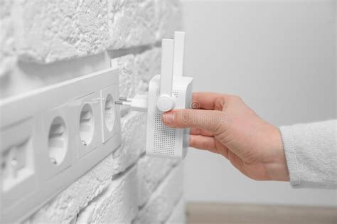 Woman Inserting Wireless Wi Fi Repeater Into Power Socket Indoors Closeup Stock Photo Image