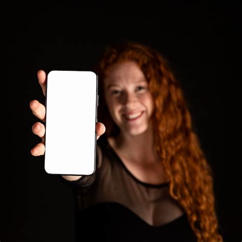 Mujer de primer plano sosteniendo un teléfono móvil Foto Gratis