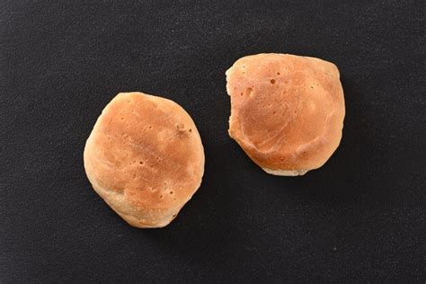 Premium Photo Two Pieces Of Bread On A Black Surface