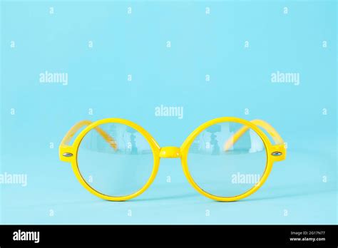 Round Yellow Glasses On Light Blue Background With Copy Space Stock