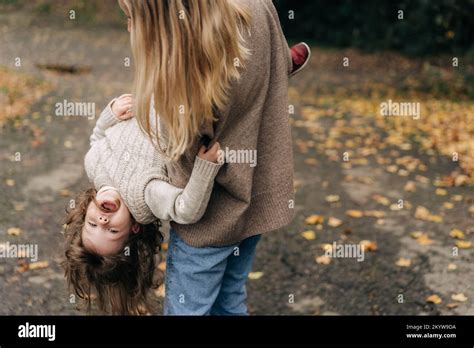 Happy Young Mother And Little Daughter Are Playing And Fooling Around