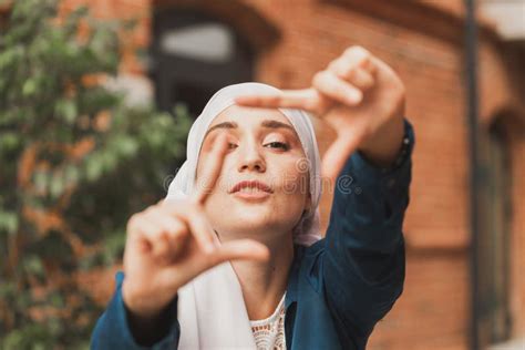 Portrait Of Young Muslim Girl Making A Camera Frame With Fingers