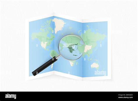 Enlarge Greece With A Magnifying Glass On A Folded Map Of The World