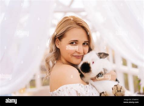 Close Up Portrait Of Charming Blonde Female In Summer Dress Cuddling