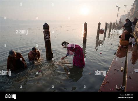Hindu Devotees Practice Ritual Bathing As The Sun Rises Over The Yamuna