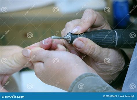 Woman Manicurist Hands Removing Cuticles From Clients Nails Using