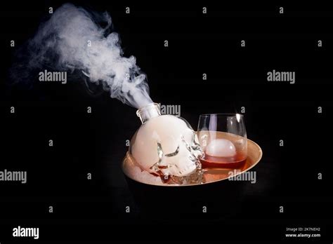 A Bottle In The Form Of A Skull With A Cocktail And A Stream Of Smoke