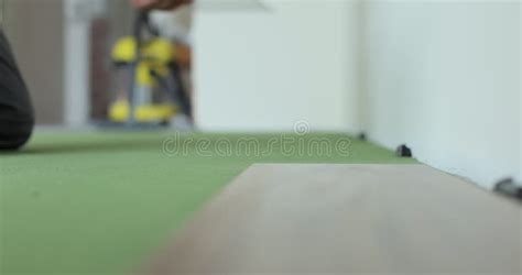 Worker Lays Laminate On A Green Backing Technology And Process Repair Of The Floor Of The