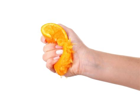 Premium Photo | Female hand squeezing orange isolated on white