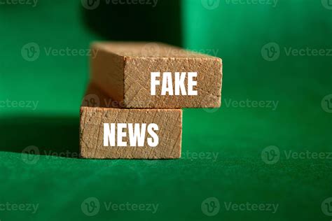 Fake News Message Written On Wooden Blocks With Green Background