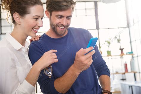 Two Young People Looking At Mobile Phone Stock Image F0151761