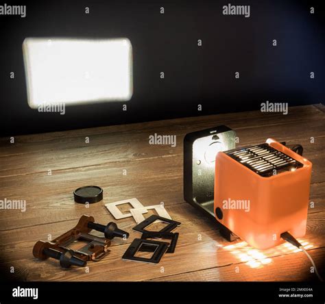 A 1970s Slide Projector Sits On A Table Next To A Slide Frame Stock