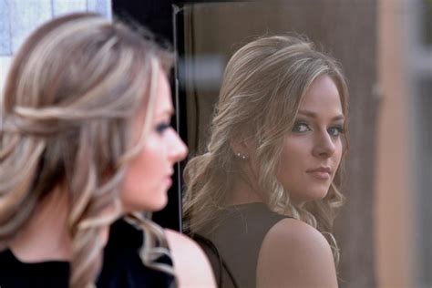 Portrait Of Young Woman Reflecting In Mirror Premium Photo