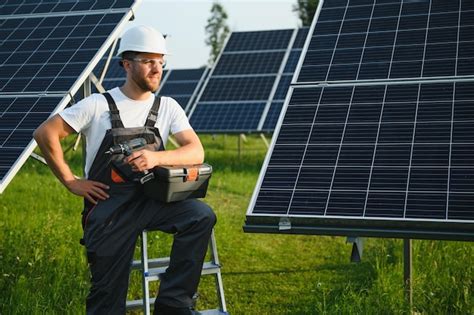 Premium Photo Side View Of Male Worker Installing Solar Modules And Support Structures Of