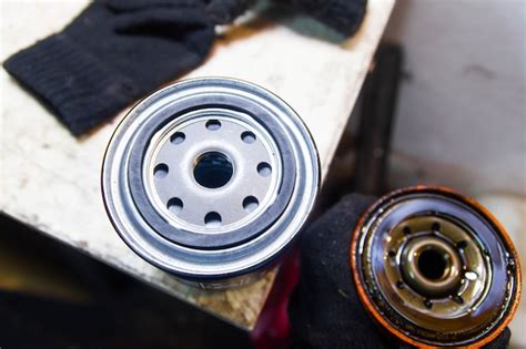 Premium Photo Replacing The Oil Filter On A Car Engine New And Old Filter