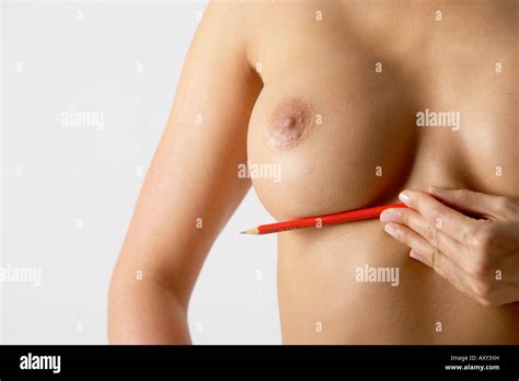 Young Woman Holding A Pencil Under Her Chest Part Of Close Up Stock