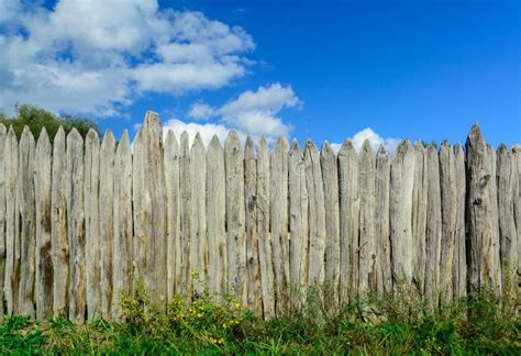 An Old Log Fence And A Blue Sky With Clouds Security And Fencing