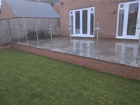Indian Sandstone Raised Patio With A Glass Balustrade Raised Planting