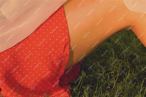 Premium Photo Midsection Of Woman Sitting On Grass