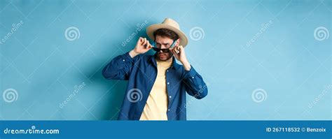 Portrait Of Guy On Vacation Staring Aside With Shocked And Cringe Face