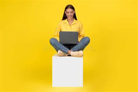 Lady Working On Laptop Computer Smiling Sitting Over Yellow Background