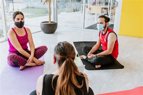 Group Of Young Latin People In Yoga Class Wearing Medical Mask In Latin