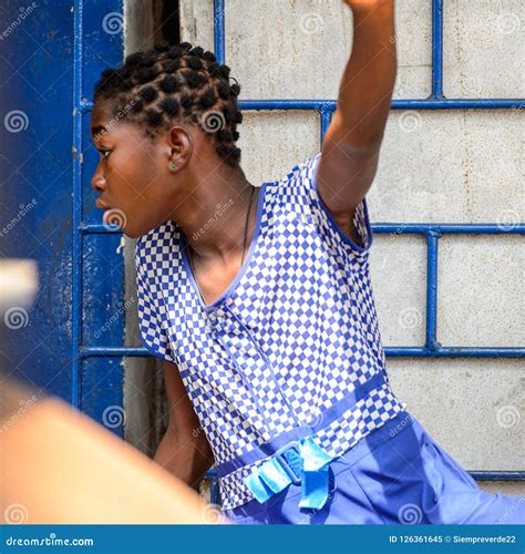 Unidentified Ghanaian Girl In Plaid Shirt Looks Away At The Editorial